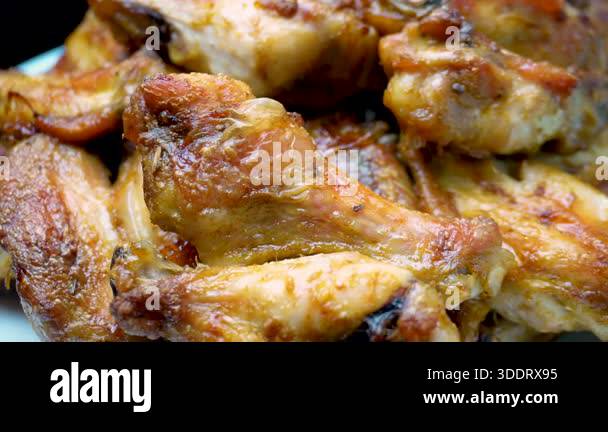 Golden fried chicken wings piled high in a mound move in a circle Stock ...