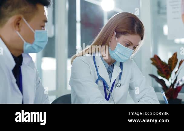 Diverse multi-cultural couple of chief asian doctor and caucasian nurse ...