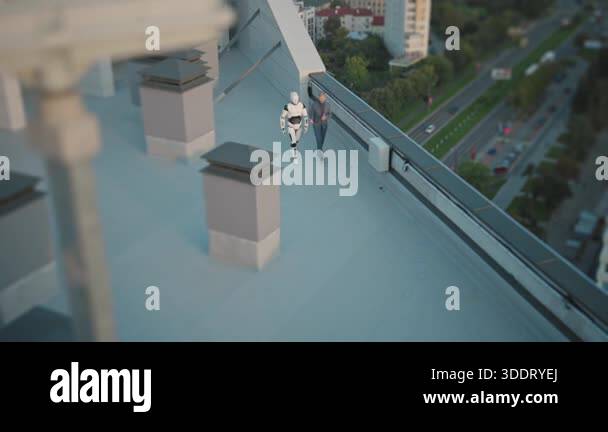 Topdown view of businessman and cyborg walking on skyscraper roof ...