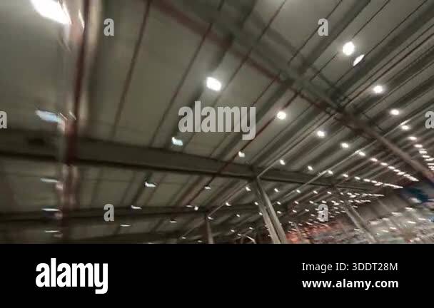 Logistic center. Aerial FPV maneuverable drone view flight over racks ...