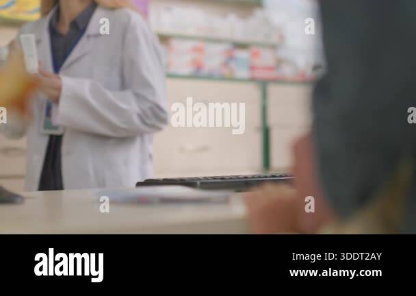 Close-up of female doctor pharmacist giving medical product to customer ...