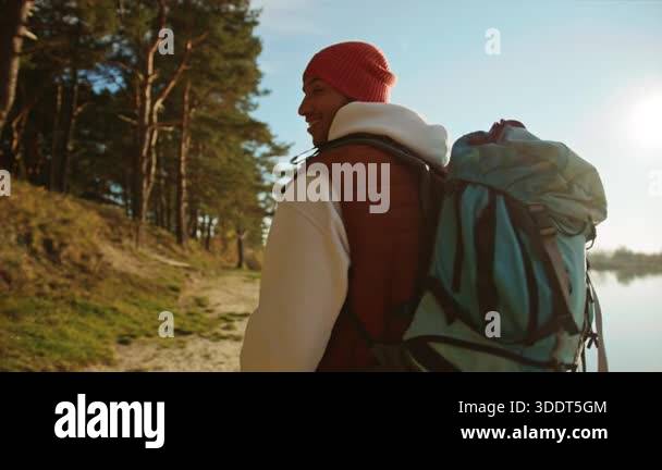 Back shot of African man with backpack holding hands of boyfriend in ...