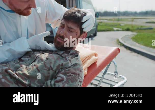 Medic provides first aid to wounded soldiers scream in pain in ...