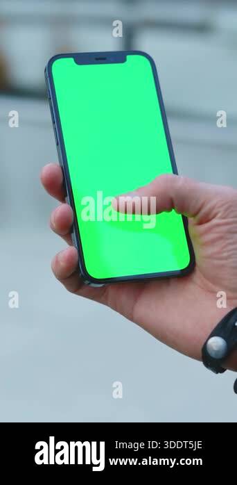A modern smartphone showcasing a vivid bright green screen, perfectly ...