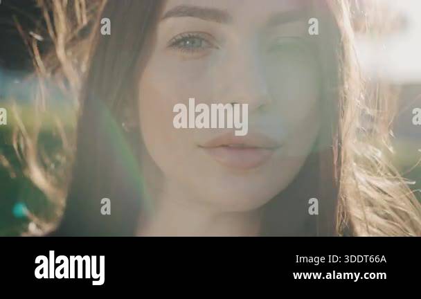 Close up face young attractive woman at sunset smiling look at camera ...