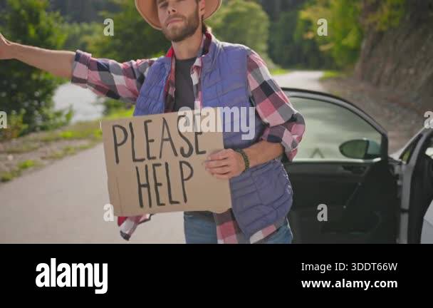 Caucasian tourist driver man holding Please Help poster hitchhiking ...
