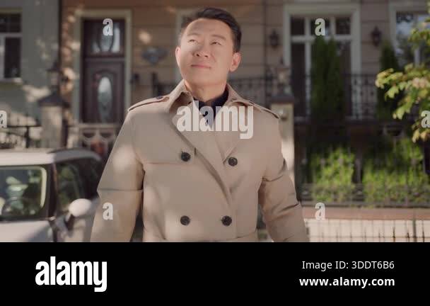 Asian attractive chinese tourist business guy wearing coat walking on ...