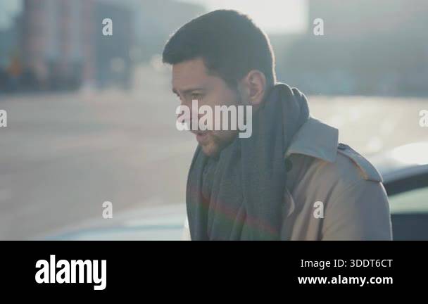 Tired unhealthy diseased young businessman sneezing allergy at parked ...