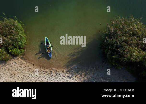 Aerial drone of young family kayaking together on peaceful lake. Father ...