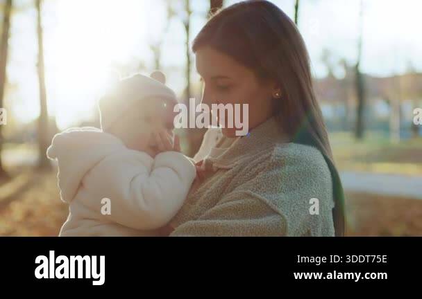 Beautiful young Caucasian mother holding cute little baby girl in funny ...