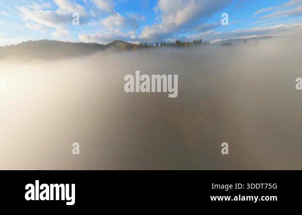 Foggy mountains. FPV view of magnificent cinematic clouds covering ...