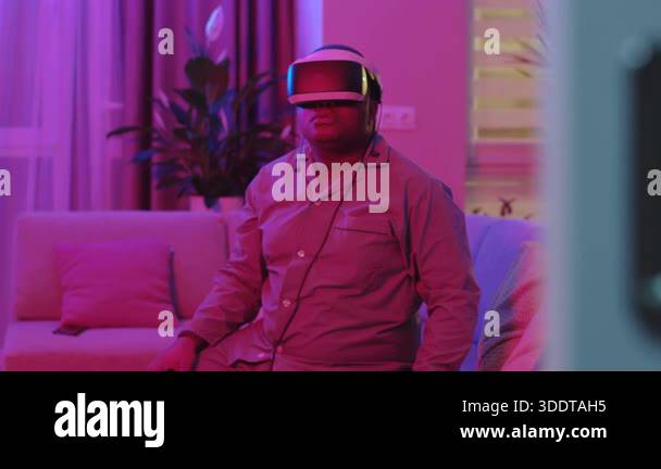 Neon light. Handsome man wearing virtual reality headset. Augmented ...