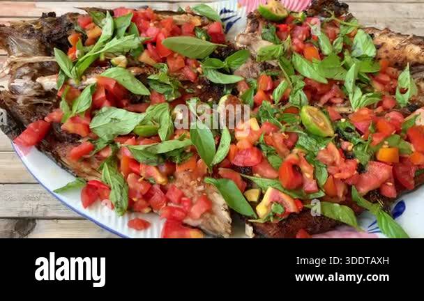fried fish with tomato and basil as toppings Stock Video Footage - Alamy