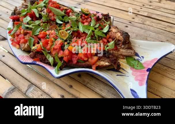 fried fish with tomato and basil as toppings Stock Video Footage - Alamy