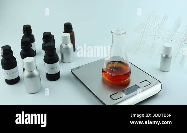 chemical beaker , flask is on digital scale white table with blotting ...