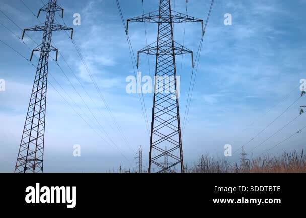 Steel Transmission Towers Against Blue Sky, Towering Pylons And ...