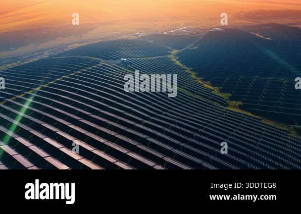 Numerous rows of solar panels cover the huge hilly territory. Orange ...