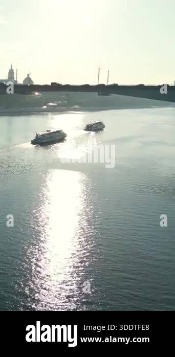 White passenger ferry boat navigating calm river under cloudy sky. Clip ...
