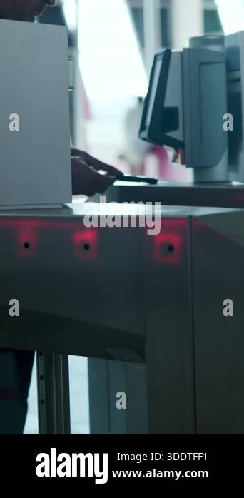 Passengers using their tickets to pass through automatic turnstile ...