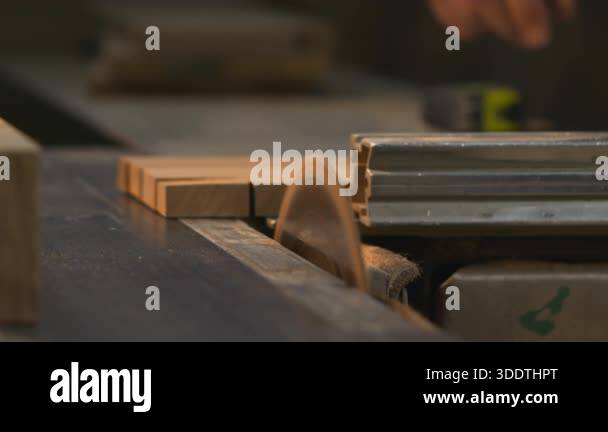 CloseUp Caucasian Woodworker Hand Guiding Final Trim Across Spinning ...