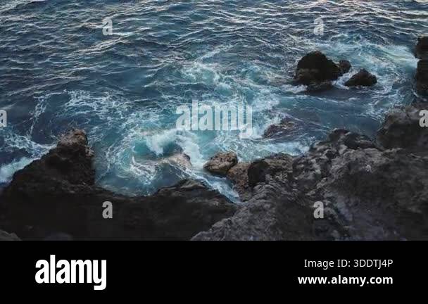 Wild beach scenery. Aerial view shot on beautiful dark rocks and ...