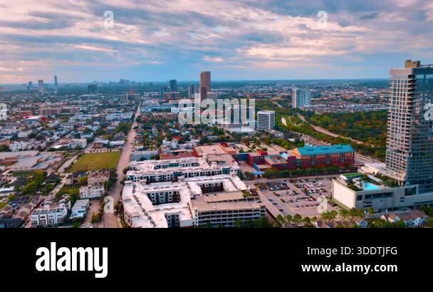 Flying over the urban landscape of modern vibrant city full of lush ...