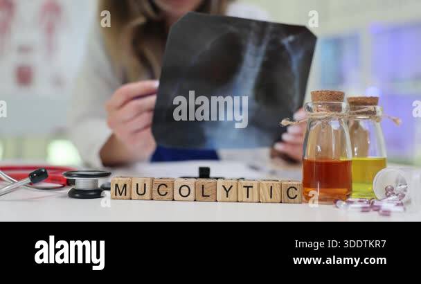 Doctor studies radiographic image comparing lung fields. Wooden blocks ...