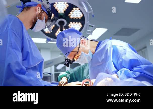 Operating surgeons cooperate at neurosurgery. Low angle view. Round ...