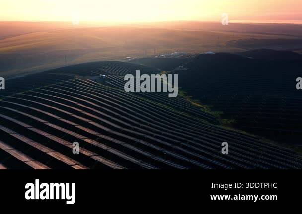 Beautiful setting sun dazzles the panorama with modern solar farm ...
