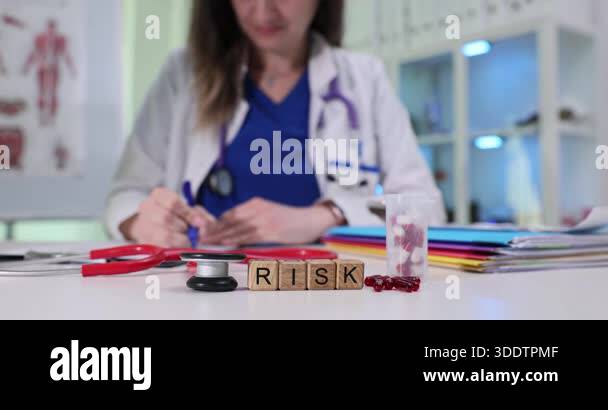 Wooden cubes spell word Risk near capsules and vial stressing medical ...