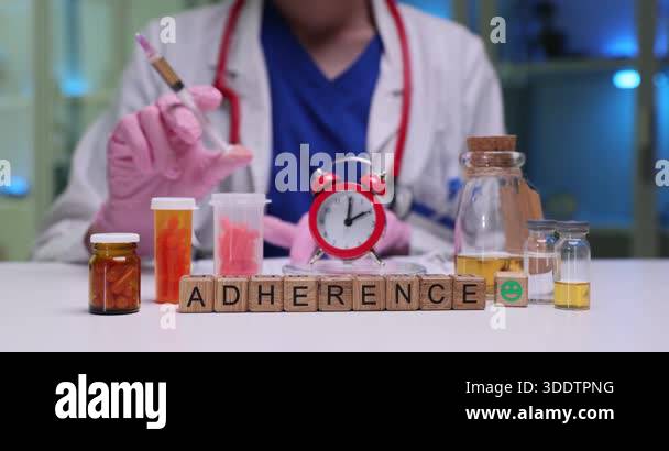 Doctor holds filled syringe and reads list of contraindications. Wooden ...