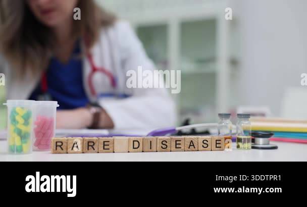 Wooden cubes spell phrase Rare Disease on doctor desk with stethoscope ...