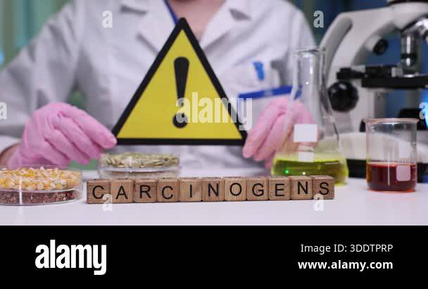 Lab worker shows warning sign to emphasize potential risks associated ...
