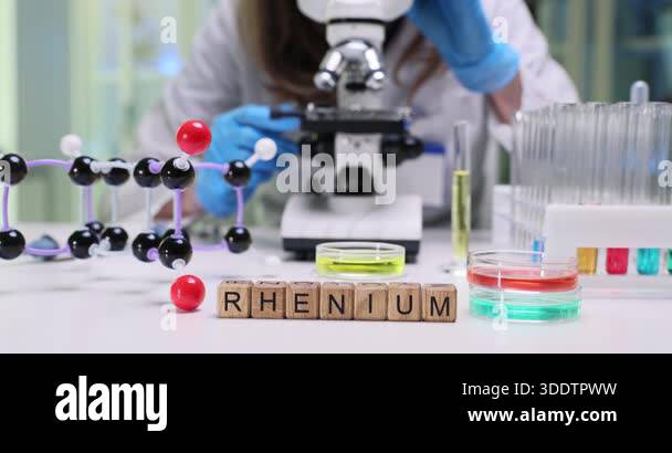 Small wooden cubes on table form word Rhenium indicating research focus ...