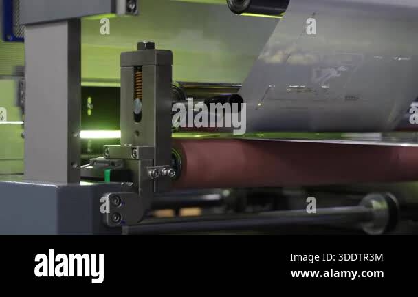 Automated printing. Industrial printing press in action with colorful ...
