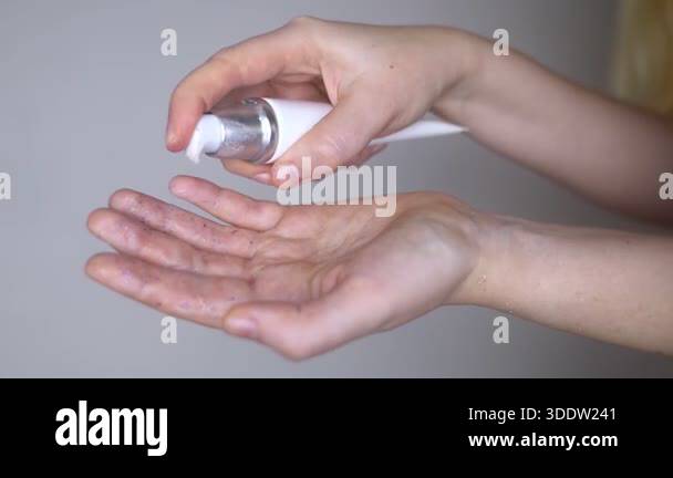 Microplastics in cosmetics. A woman applied a care cream to her skin ...