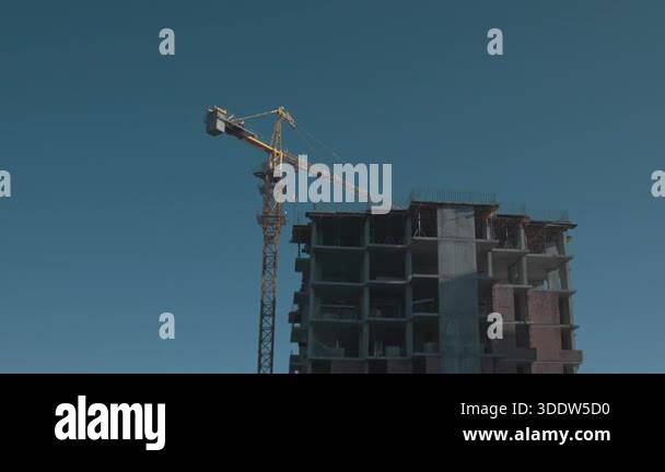 Drone aerial footage of new constructions site. High tower crane above ...