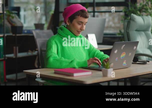 Happy excited young transgender person received good news while working ...