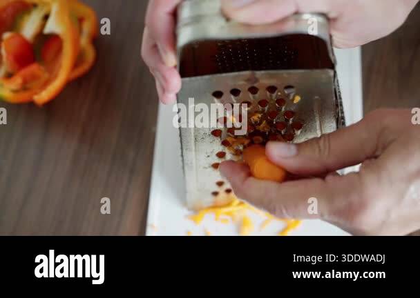 Grating Carrot Over White Board, Caucasian Hands Rub Orange Vegetable ...