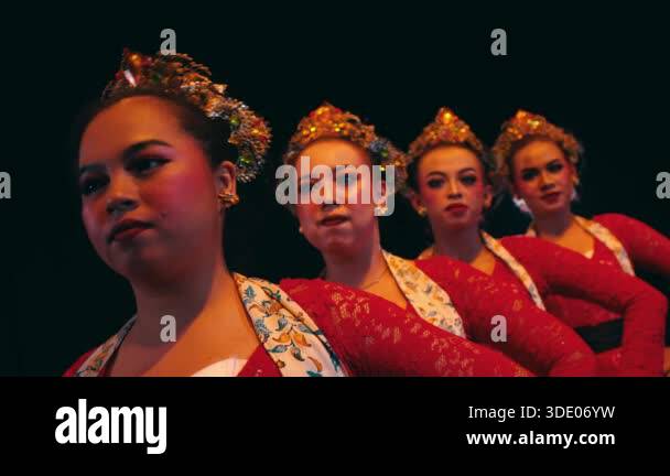 A dynamic low-angle tracking shot along the faces of four Javanese ...