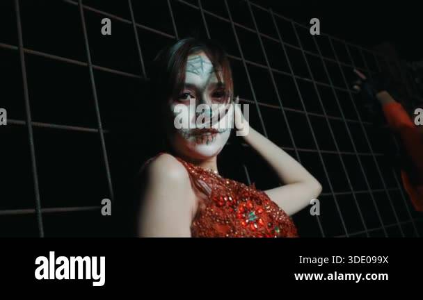 A dramatic, low-angle close-up of a woman in beautiful 'Day of the Dead ...