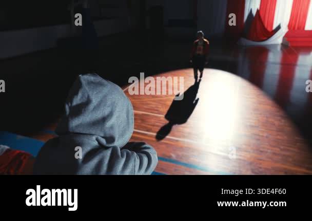 A medium close-up profile shot of a woman in a red circus ringmaster ...