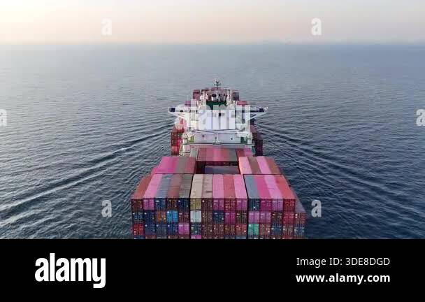 4K Back view of a large container cargo ship traveling over the ocean ...