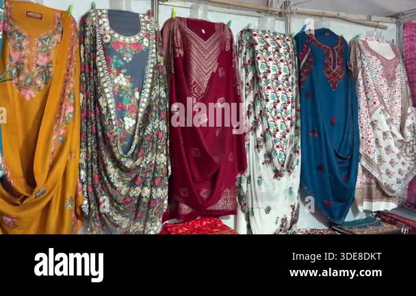 traditional indian kurtis hanging on clothing rack in local shop Stock ...