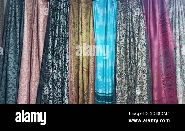 traditional indian clothing textiles hanging in local market stall ...