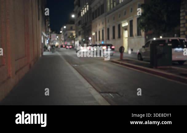 Nighttime rome street scene with soft bokeh and defocused city lights ...