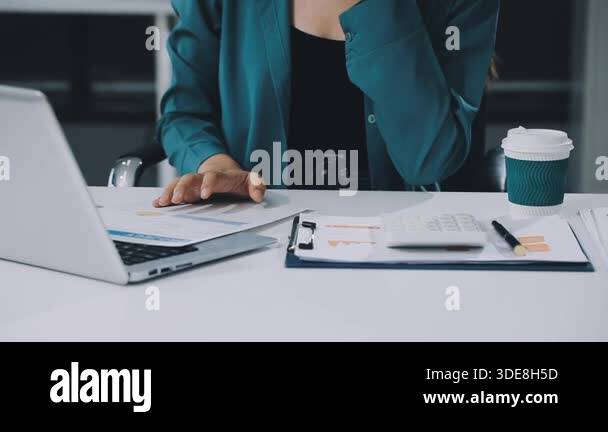 businesswoman using a calculator to calculate the numbers for financial ...