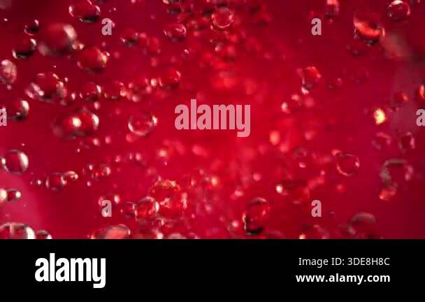 Super Slow Motion Shot of Flying Red Lemonade Liquid Drops Towards ...