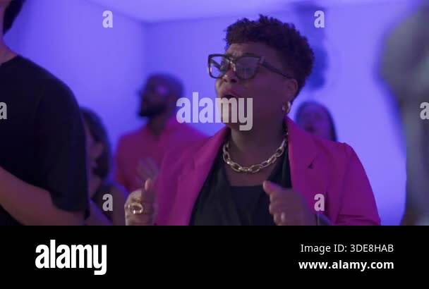 African American woman with short hair leading evangelical worship with ...