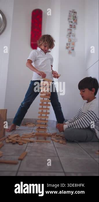 Children stack wooden blocks side by side expressing coordination ...